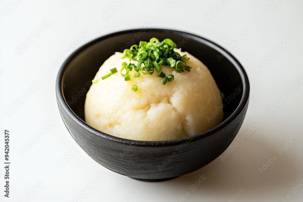 A steaming bowl of fufu, a traditional West African dish made from ...