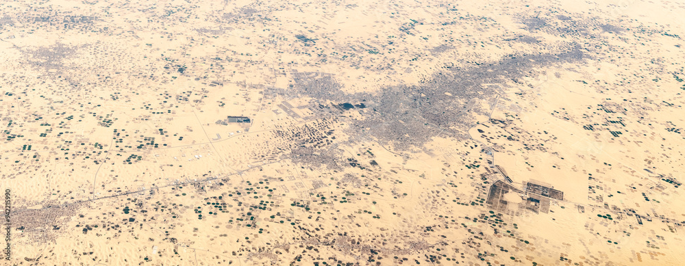 Aerial view of arid Sahara desert dried lands sandy reg with dried out ...