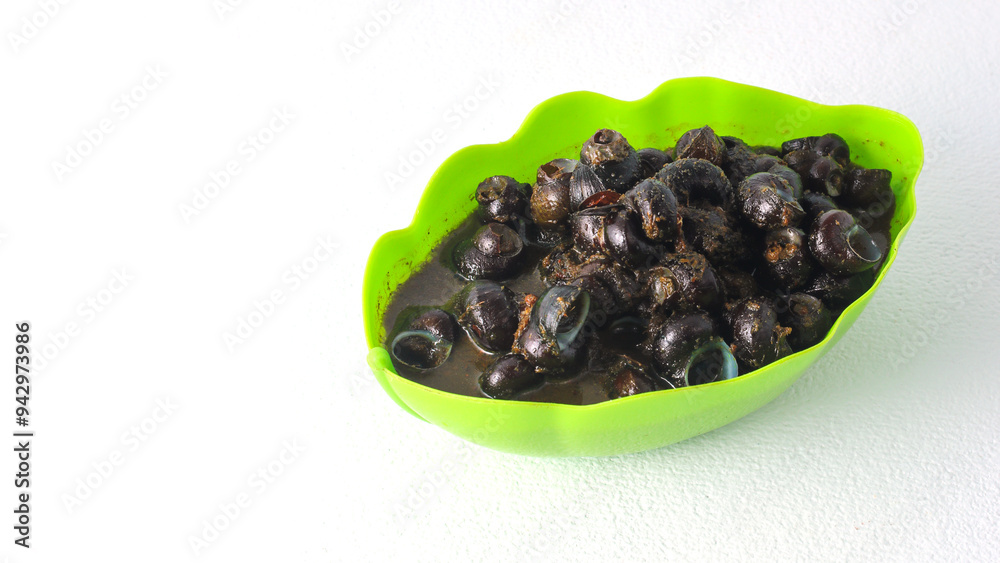A bowl filled with cooked river snails (tutut) in a spicy sauce. Tutut ...