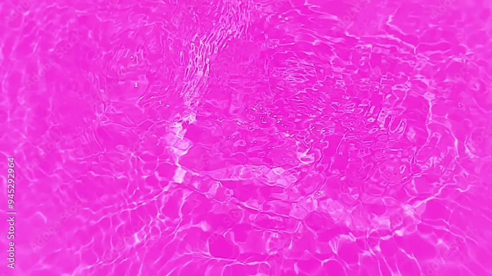 Pink water bubbles on the surface ripples. Defocus blurred transparent ...