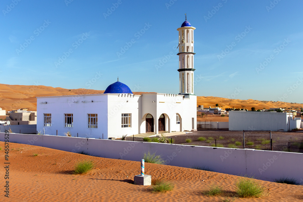 Mosque in city of Al Raqa among sand and sand dunes. Sultanate of Oman ...
