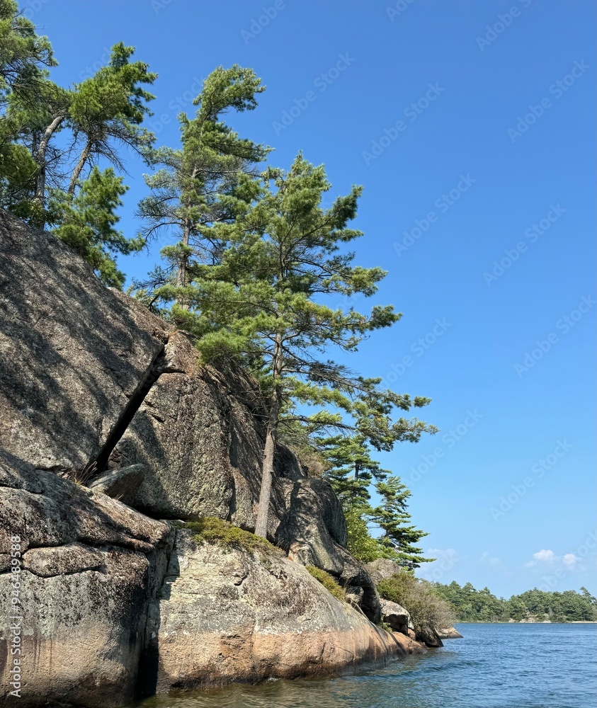 Pointe au Baril Day Granite island cliffs with pine trees in Georgian ...