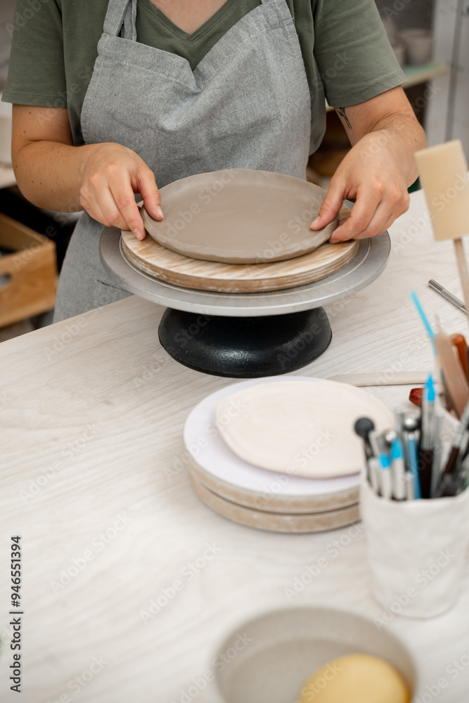 Creating ceramic products from flat sheets of clay. Using hands to ...
