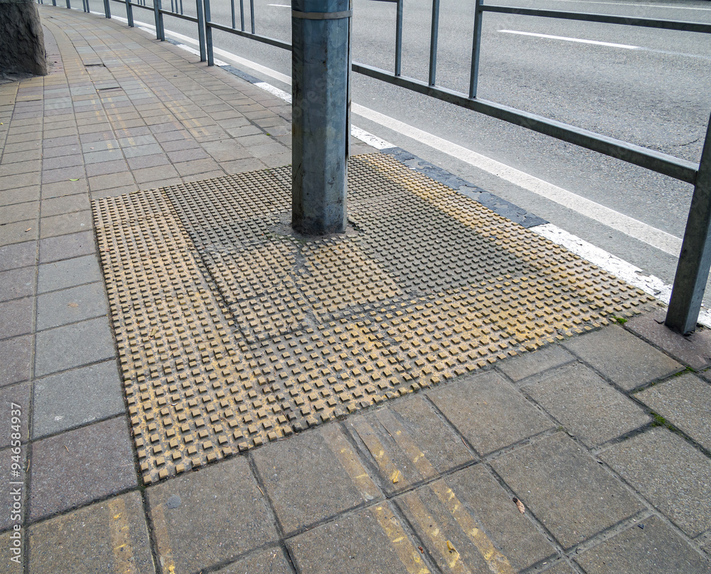 Tactile zone on the sidewalk around the lamp post Stock Photo | Adobe Stock