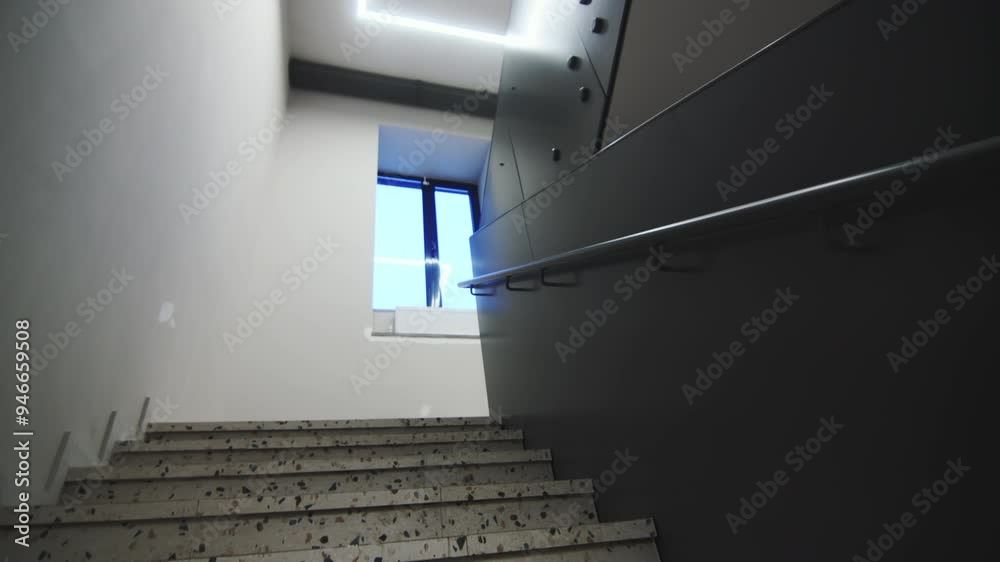 Staircase with creative design in hall of high-rise building. Light ...