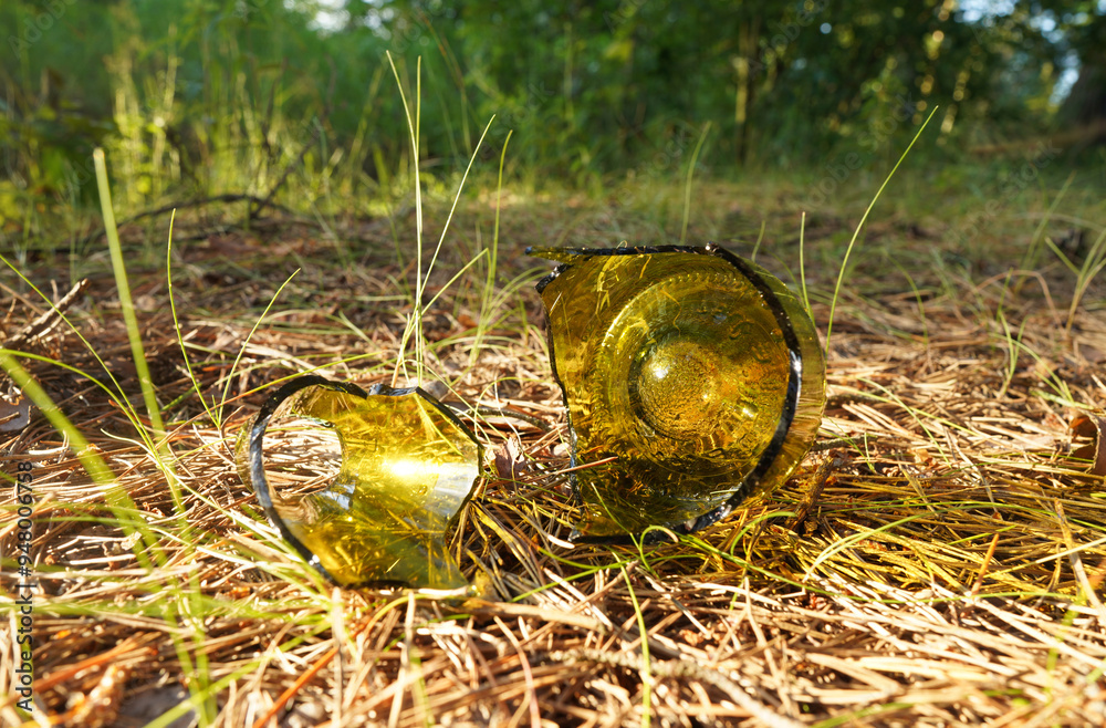 Broken glass bottle on ground. Broken Glass on ground in the forest ...