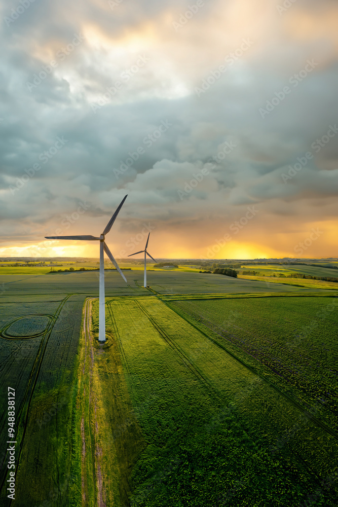 Wind turbines that produce electricity, built on a field in Skanderborg ...