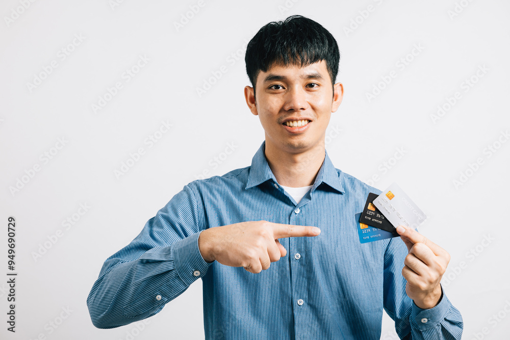 Portrait Asian smiling young man holding debit credit cards in his hand ...