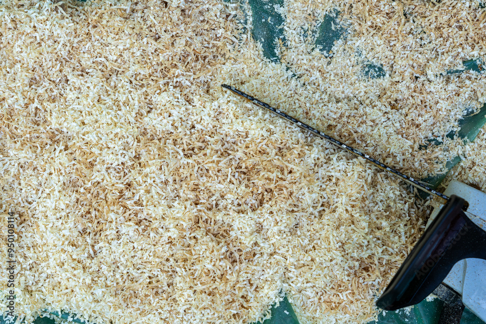 Yellow wood chipping, mulch created by cutting wood with chainsaw to be ...