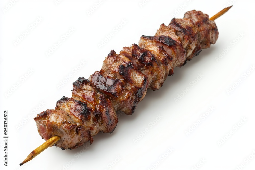 a single grilled pork shish kebab, placed vertically on a white ...