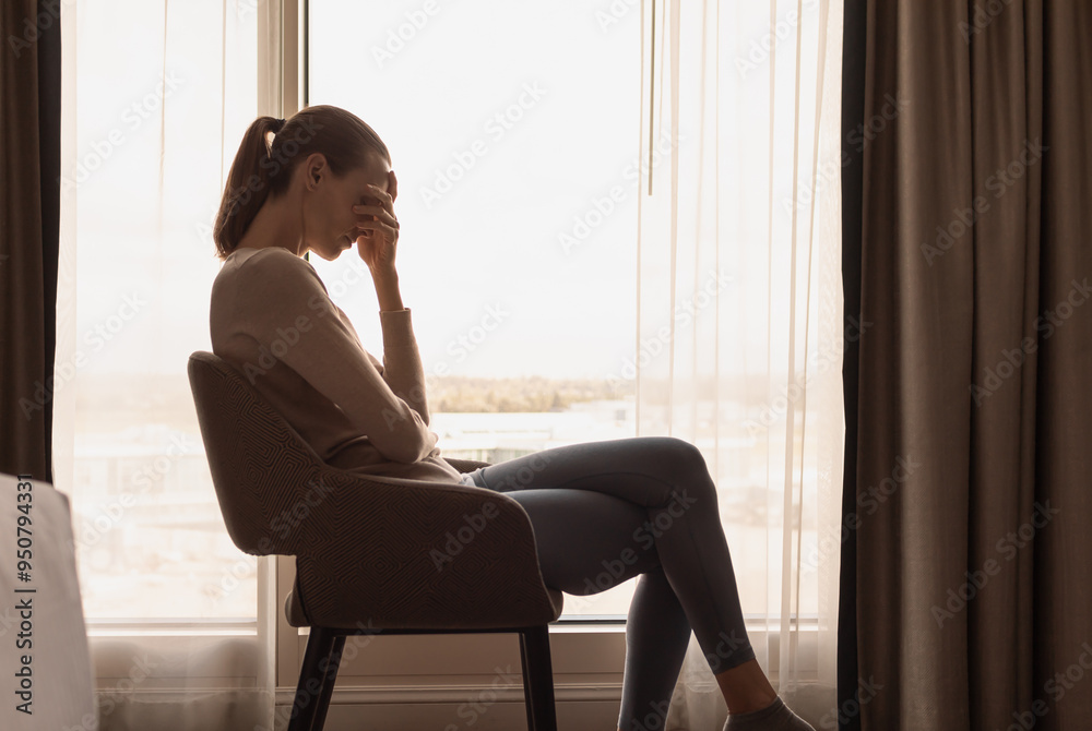 sad woman in a dark room with head down, Portrait of thoughtful sad ...