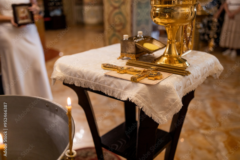 Metal basin (font) with three candles for bathing babies during the ...