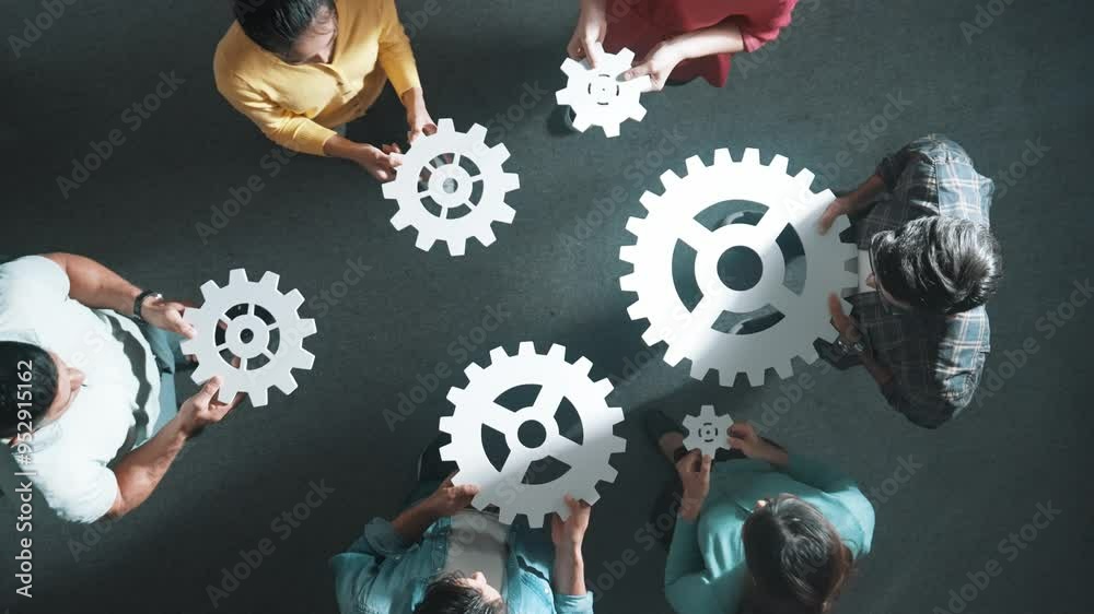 Top down aerial view of business team working together to gather cog ...