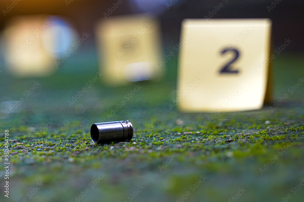 Bullet casings fall on cement floor and blurred background of evidence ...