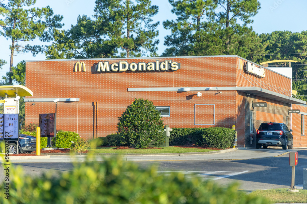 Exterior view of a McDonald's restaurant with a drive-thru, featuring ...