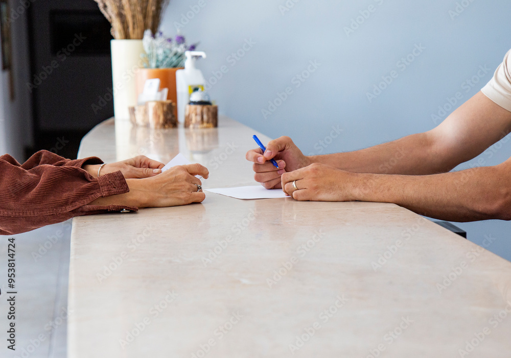 hand giving a registration card to a hotel guest, hotel check-in ...