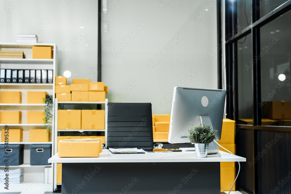desk with a cardboard box sits alone in office, reflecting a quiet ...