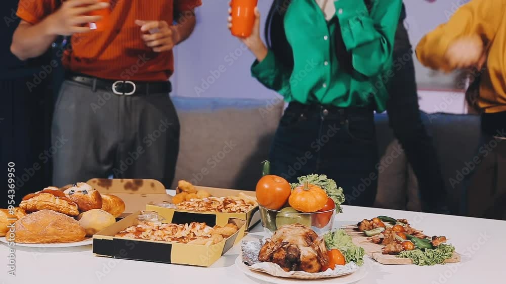 Diverse group of young people eating pizza at house party 80s style ...