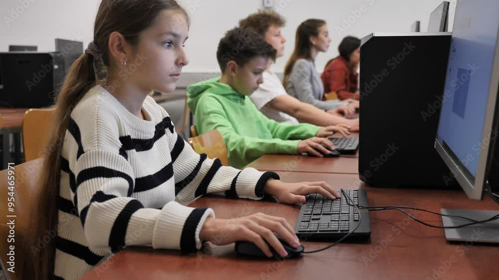 Portrait of interested tween girl during lesson in computer room of ...