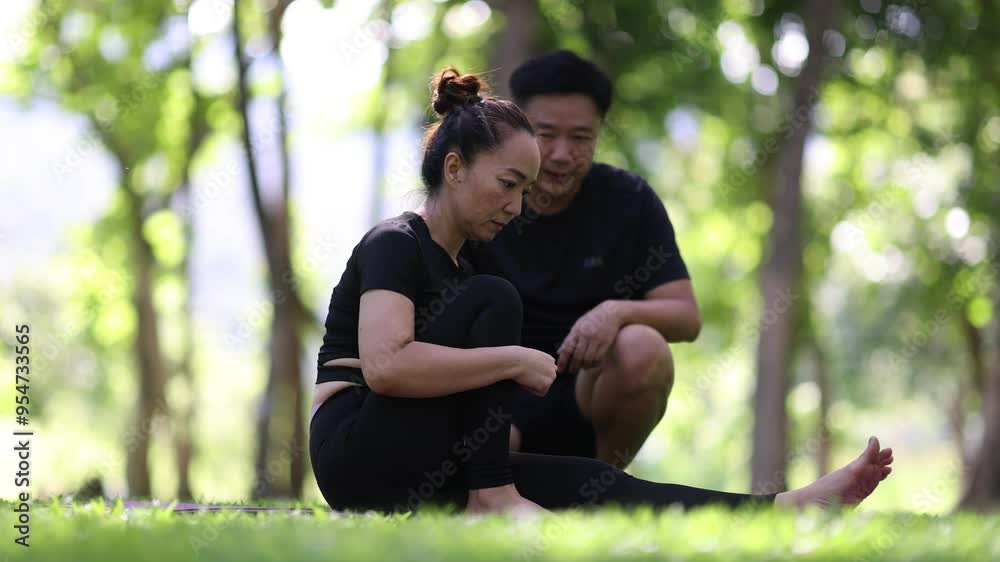 Advanced outdoor yoga poses with instructor helping woman. Professional ...