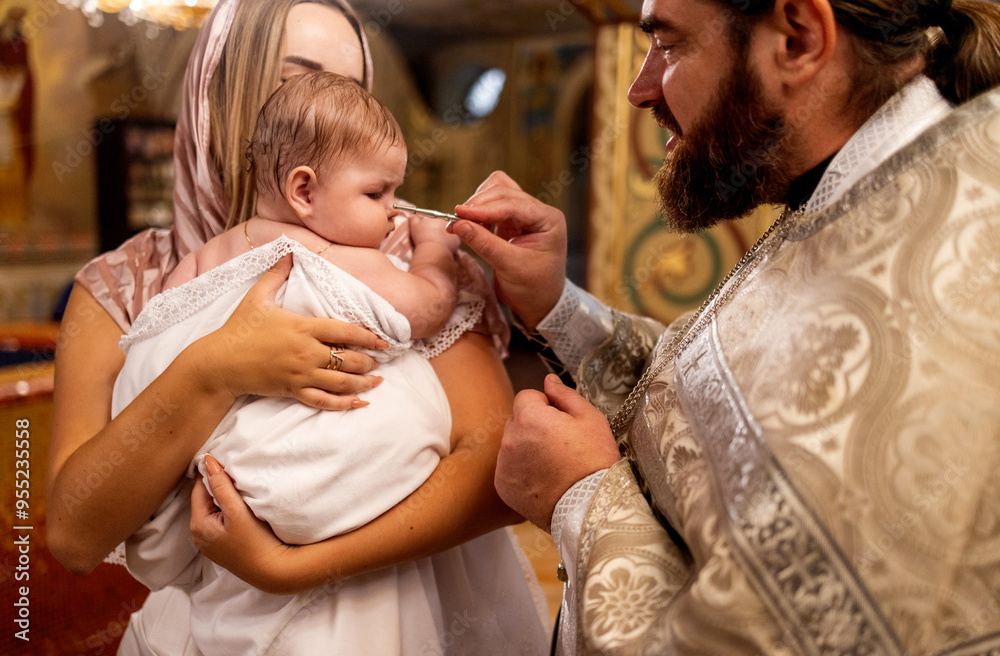 Newborn baby baptism in Holy water. Infant bathe in water. Baptism in the font. Sacrament of ...