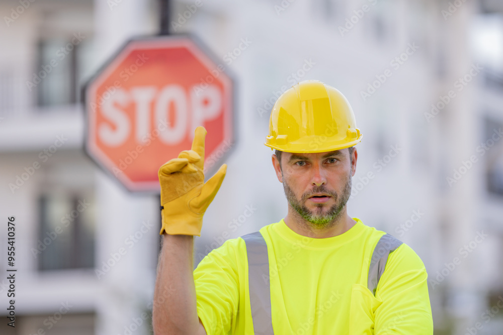 Man in hard hat helmet doing stop sign with serious and confident ...