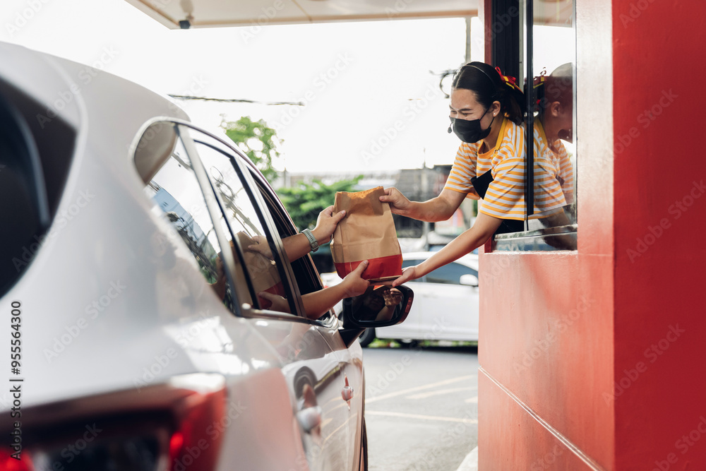 Hand Man in car receiving coffee in drive thru fast food restaurant ...