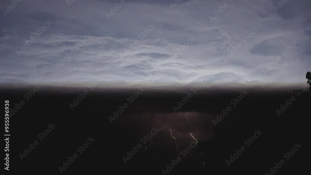 A multitude of different shapes of lightning streaks across the dark ...