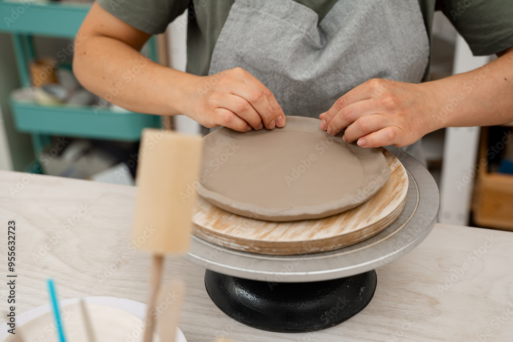 Creating ceramic products from flat sheets of clay. Using hands to ...