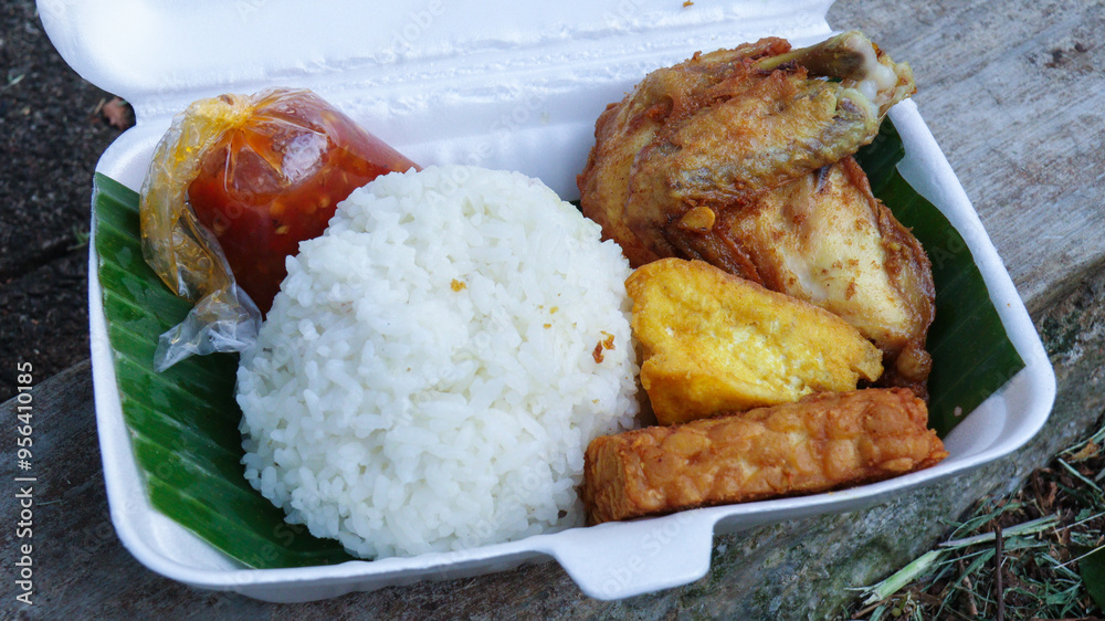 A styrofoam food container filled with a traditional Indonesian meal ...