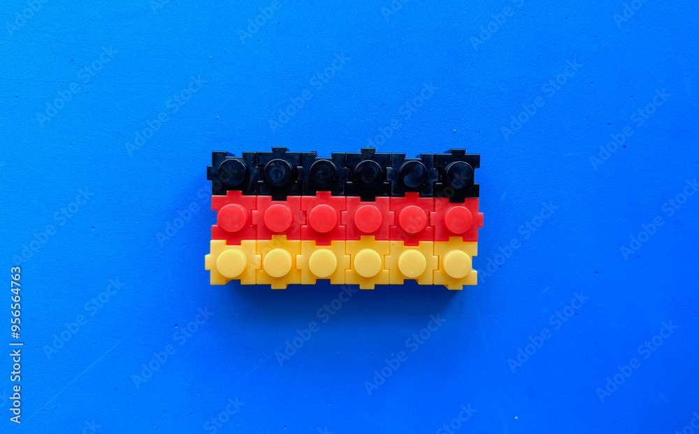 German flag on a blue background, built from a children toy ...