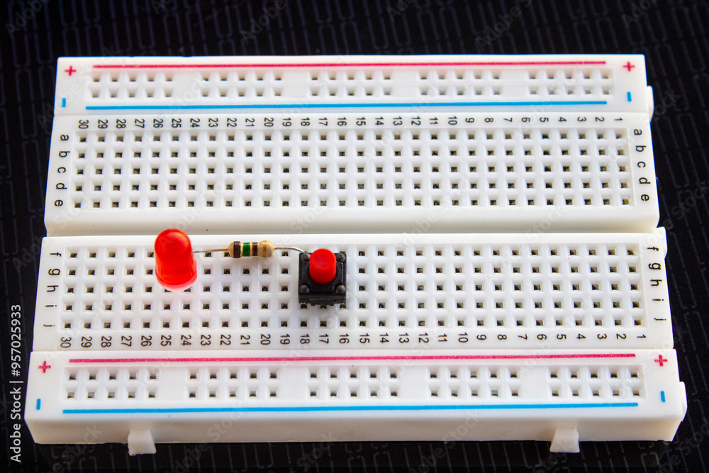 Small breadboard with colorful LED connected using cable and jumper ...