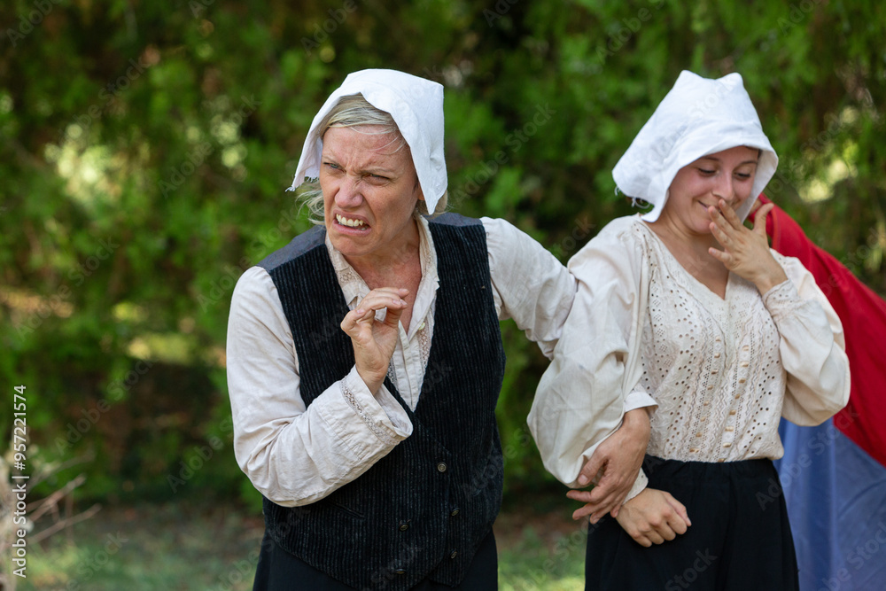 Two women in traditional french costumes showing disgust and shame ...
