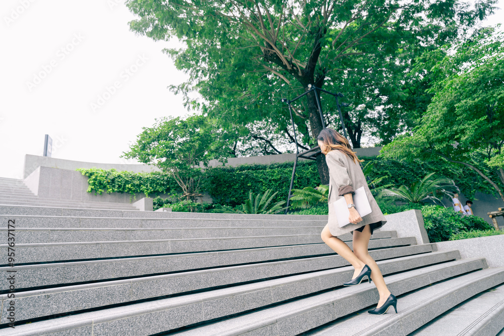 Asian business woman walking to work diligently and briskly in morning ...