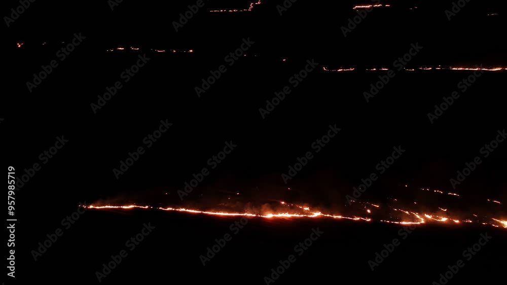 Raging fire at the dry grass meadow. Agricultural field fire burning ...