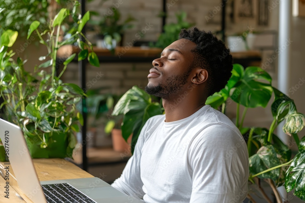 At their desk, the employee is calming their mind by doing breathing ...