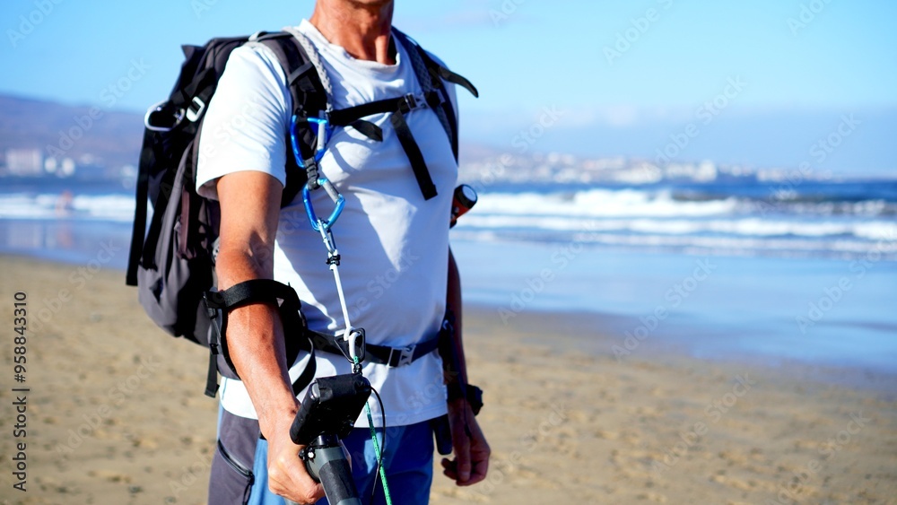 Young man holding a metal detector. Close-up view from below of human ...