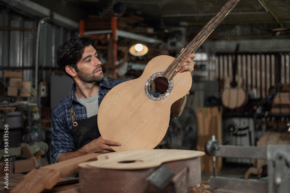 Luthier creating a guitar and using tools in a traditional Stock Photo ...