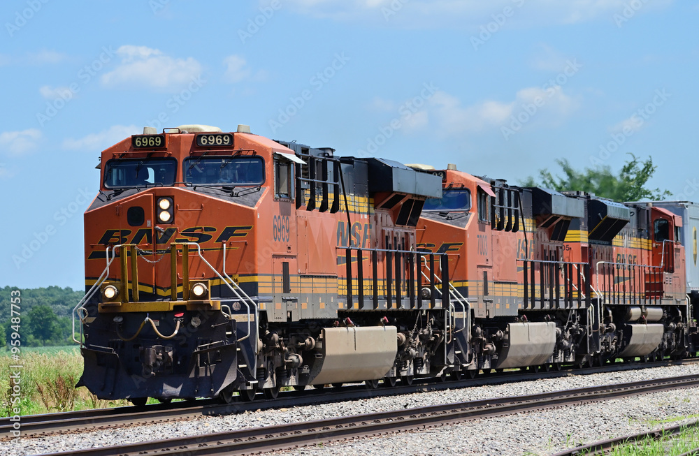 Four locomotives lead an intermodal freight train westbound through ...