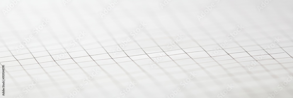 The photograph features a closeup of a neatly textured white grid paper ...
