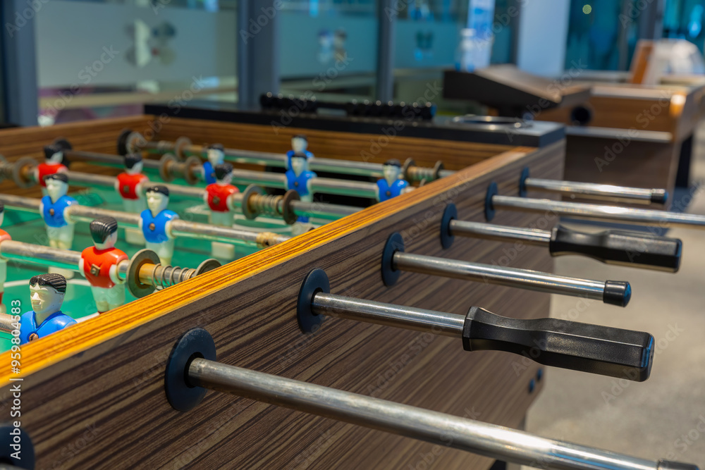 Retro table soccer with wooden miniature figurines of players on metal ...