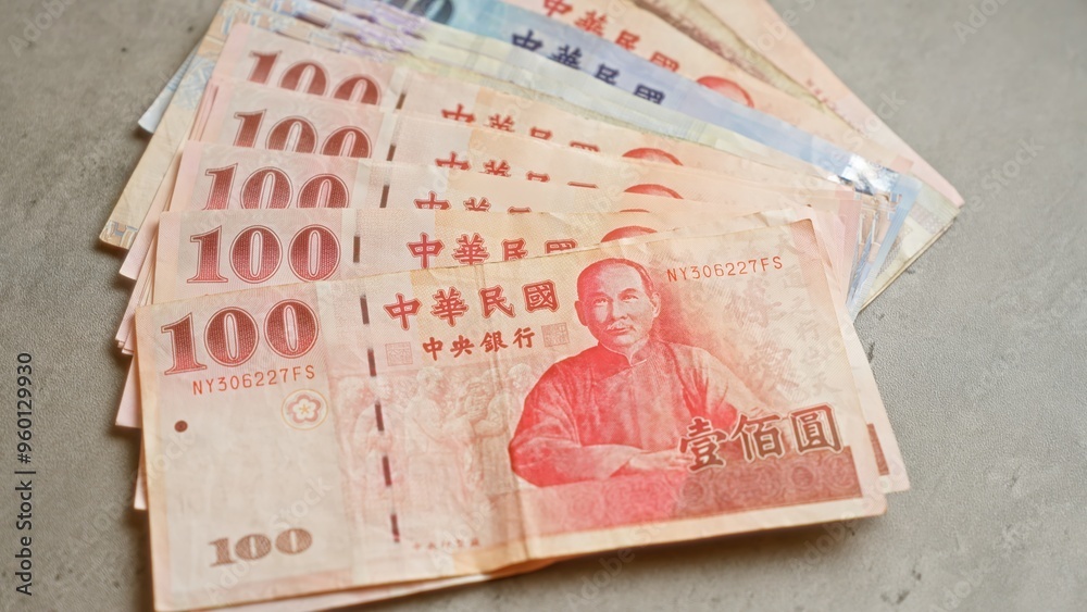 Chinese yuan banknotes spread out on a concrete surface, showcasing the ...