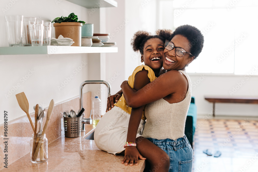 Mama's love: Happy black mom hugging her daughter in the kitchen Stock Photo | Adobe Stock