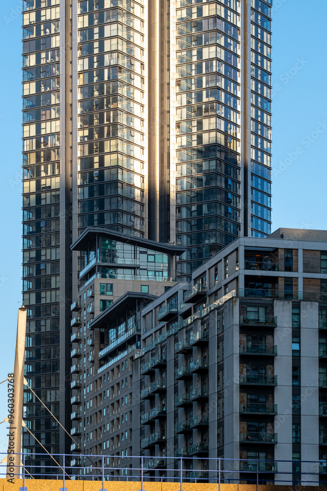 Sunlit tall buildings and apartments in a high-rise complex ...