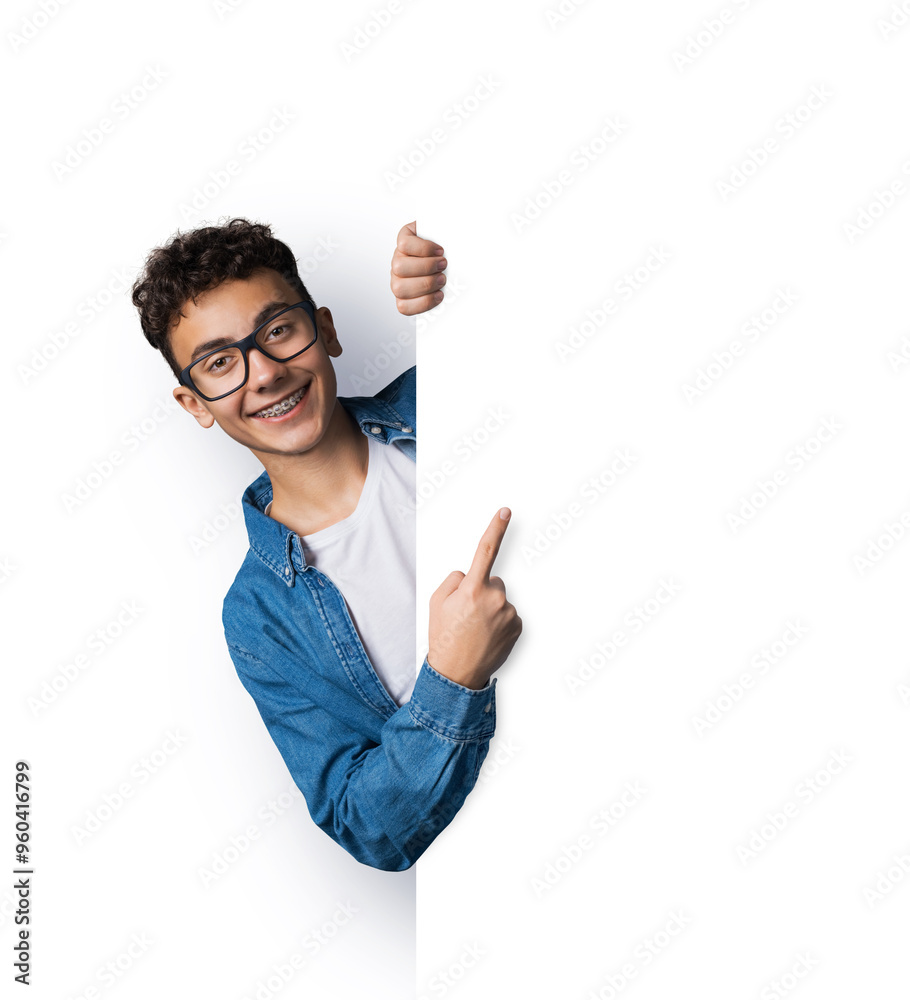 Excited young man wear eye glasses, braces, stand behind, peep from ...