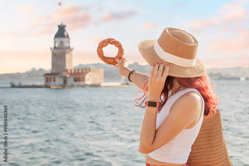 A picturesque view of the Bosphorus with a girl savoring her simit ...