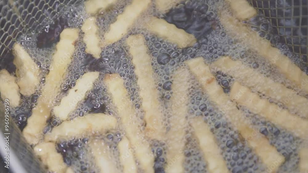french fries potato chip fried in deep fryer with hot cooking oil in ...