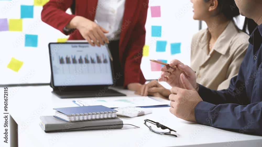 Data-Driven Collaboration: A team huddles around a laptop, analyzing ...