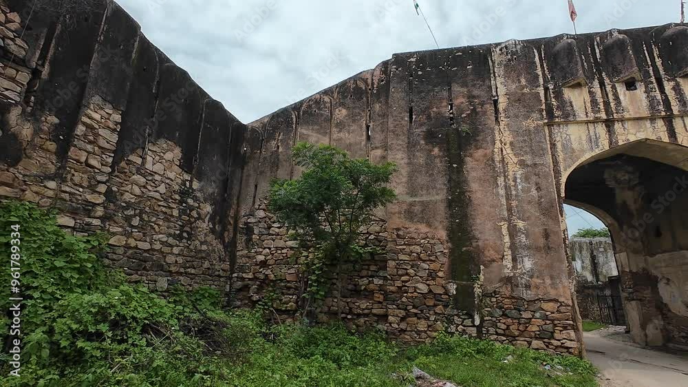 Medieval Fort Entrance with Moss-Covered Walls and Pathway, Jaipur ...