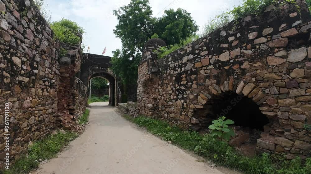 Medieval Fort Entrance with Moss-Covered Walls and Pathway, Jaipur ...